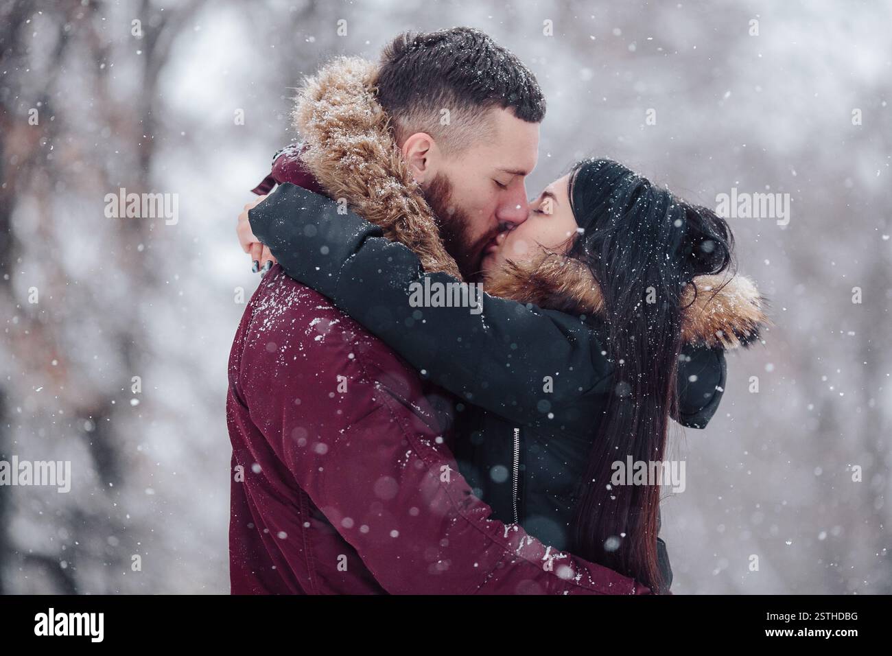 Beautiful young couple kissing Stock Photo - Alamy