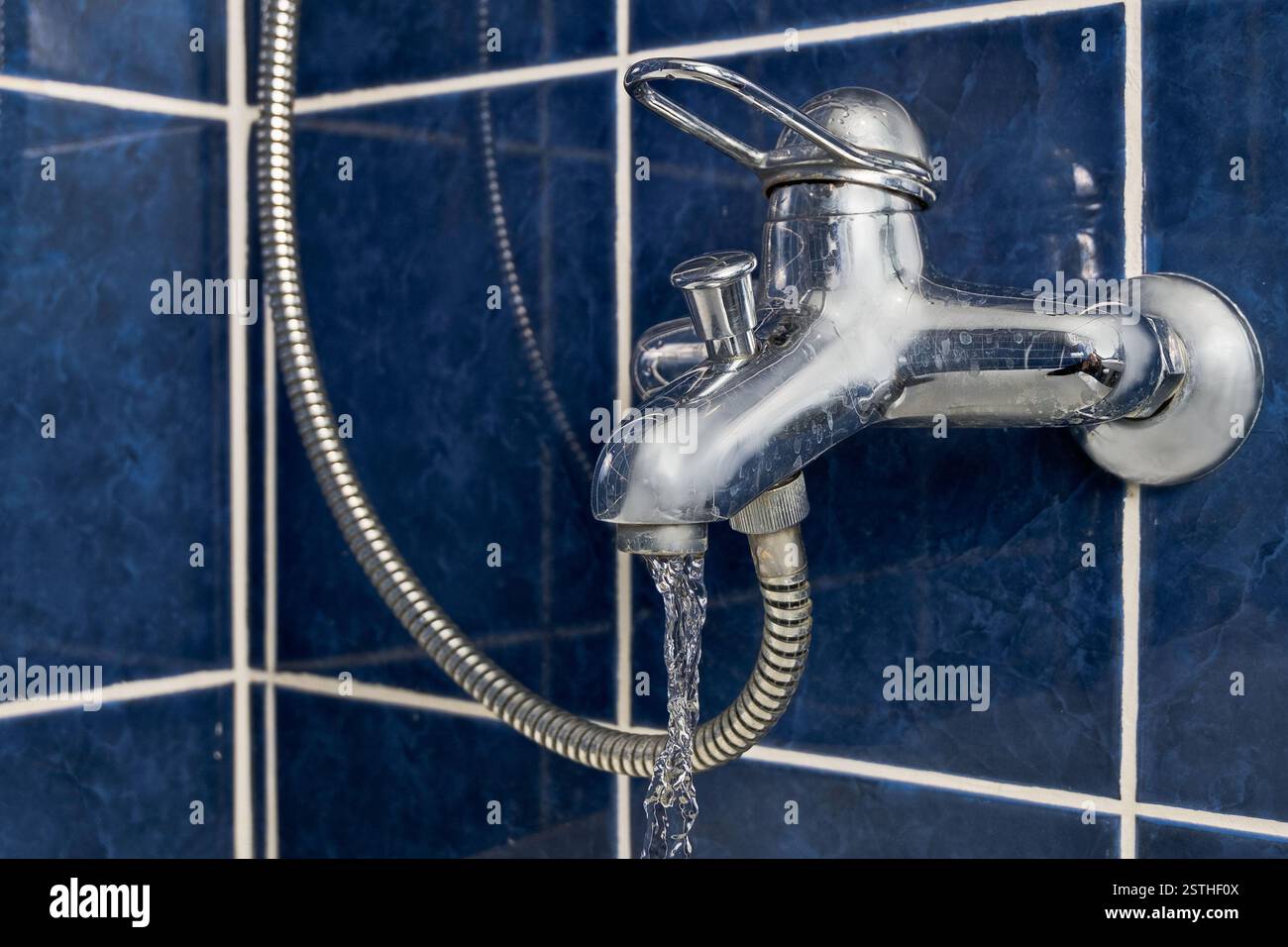 Chromium-plate tap angle view with water flow out frozen in air front ...