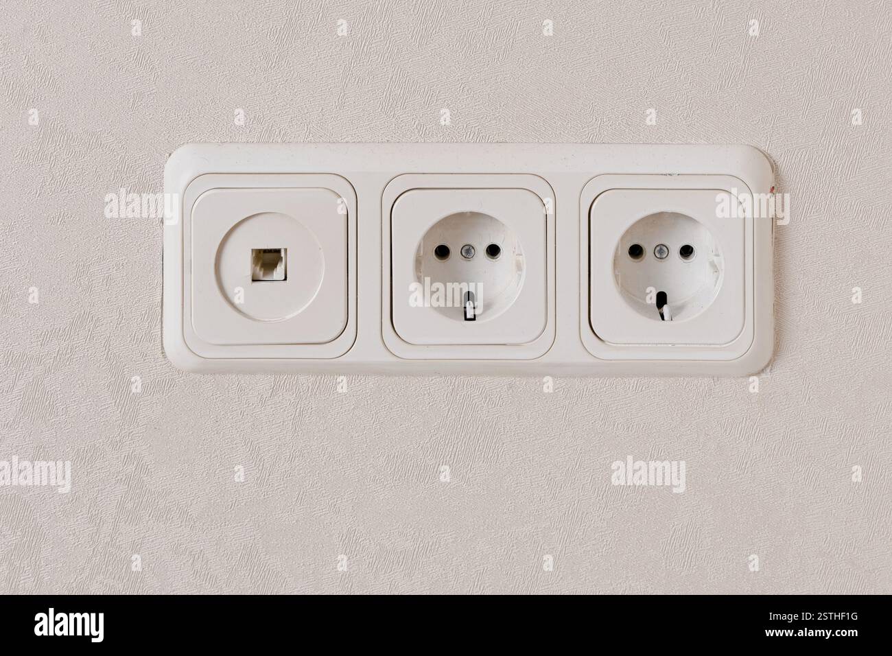 Two electric outlets on wall EU standart and telephone plug Stock Photo ...