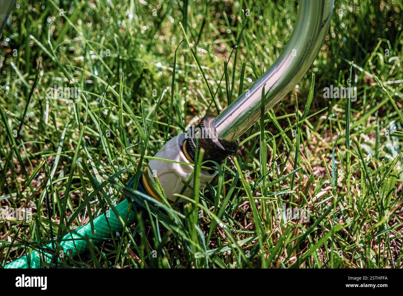 Plastic and metal pipe coupling of yard irrigation system Stock Photo - Alamy