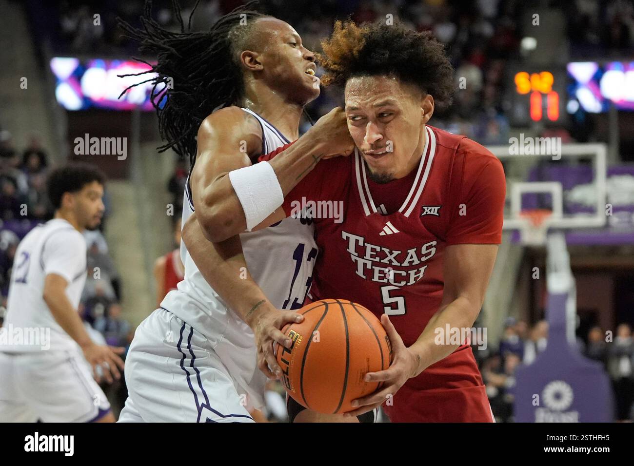 Texas Tech forward Darrion Williams (5) tires to get around TCU forward ...
