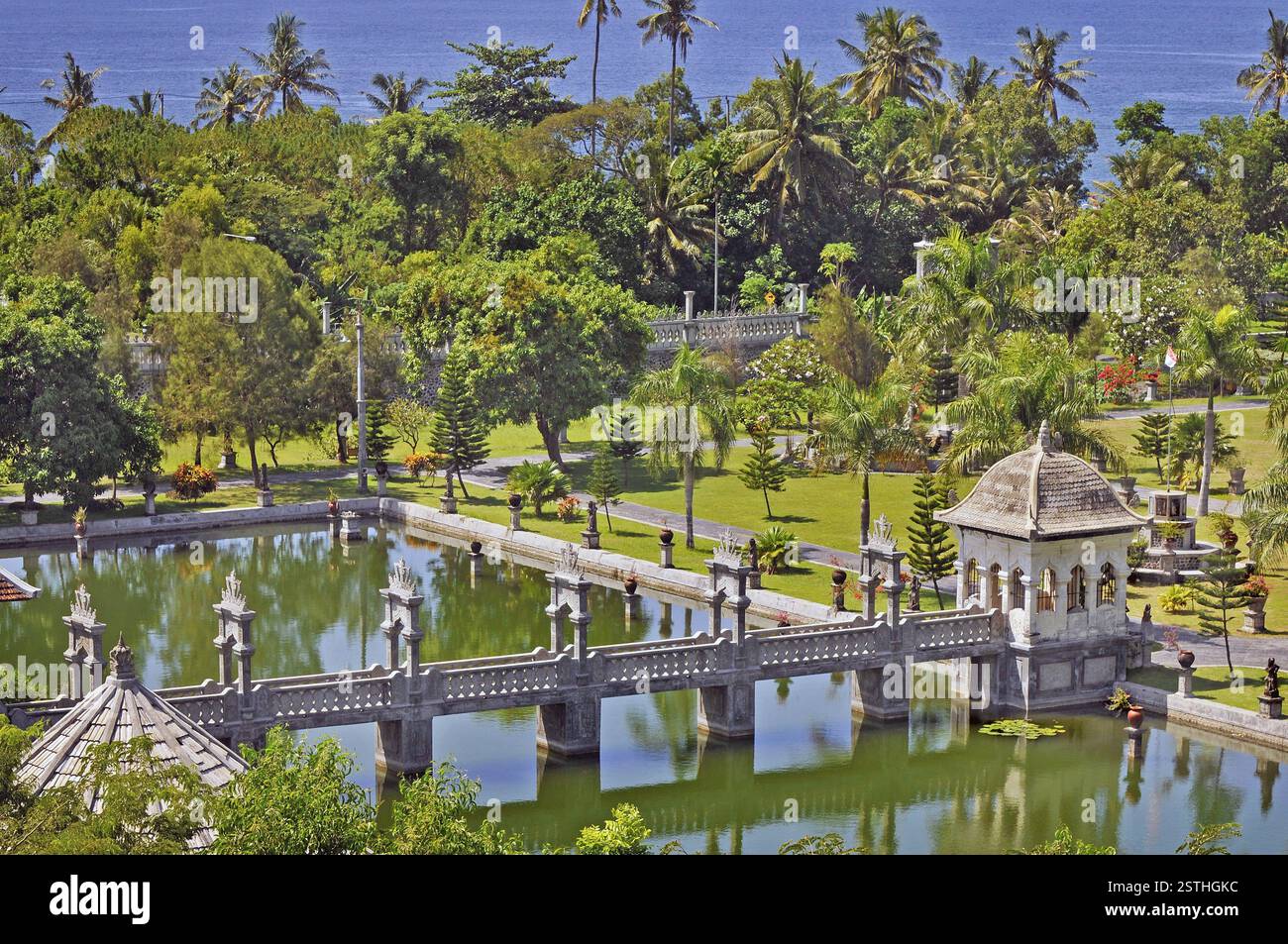 Pond with stone bridge at the Taman-Ujung water palace, Bali, Indonesia ...