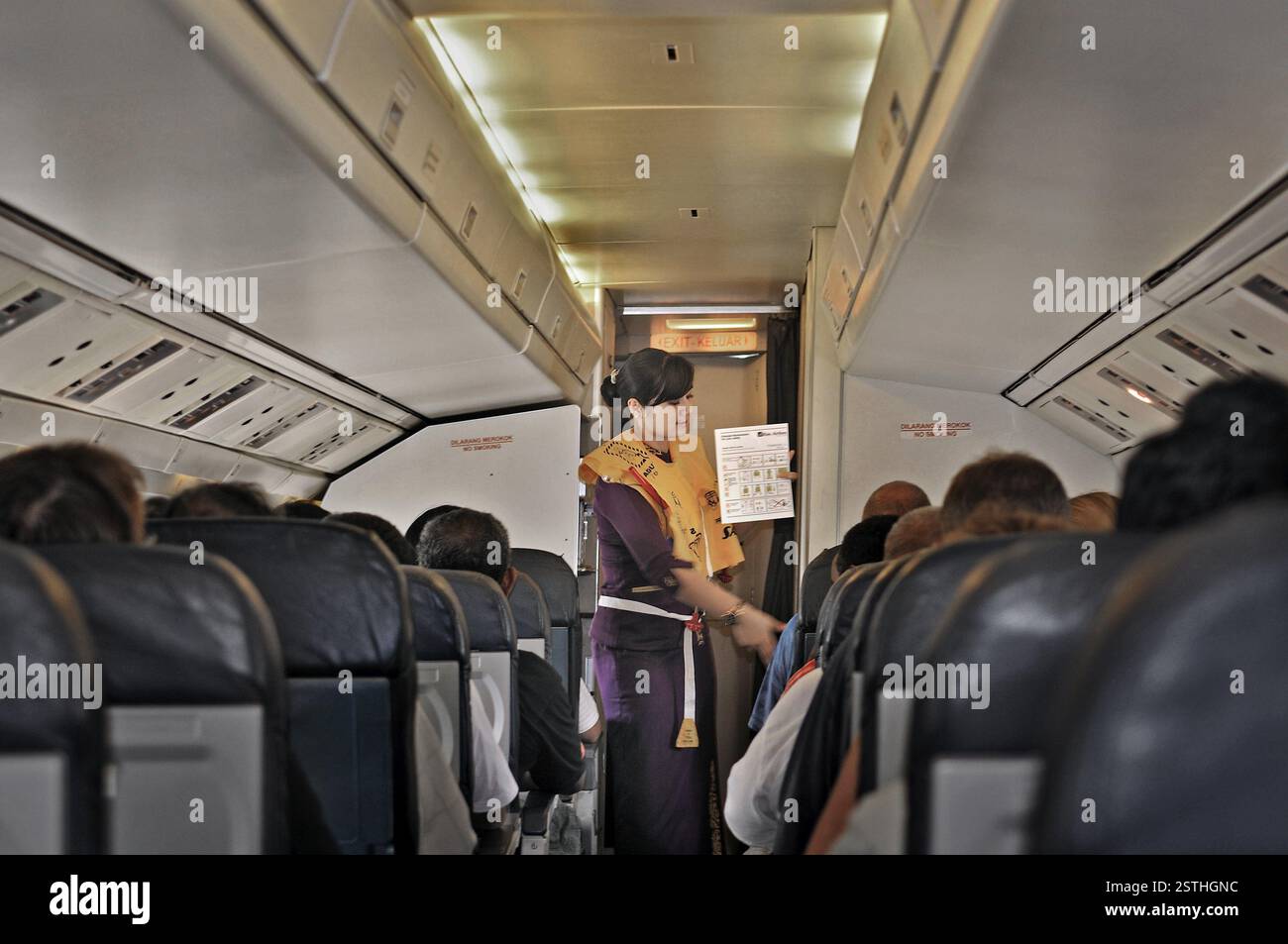 Flight attendant, obsolete stewardess explaining the function of the ...