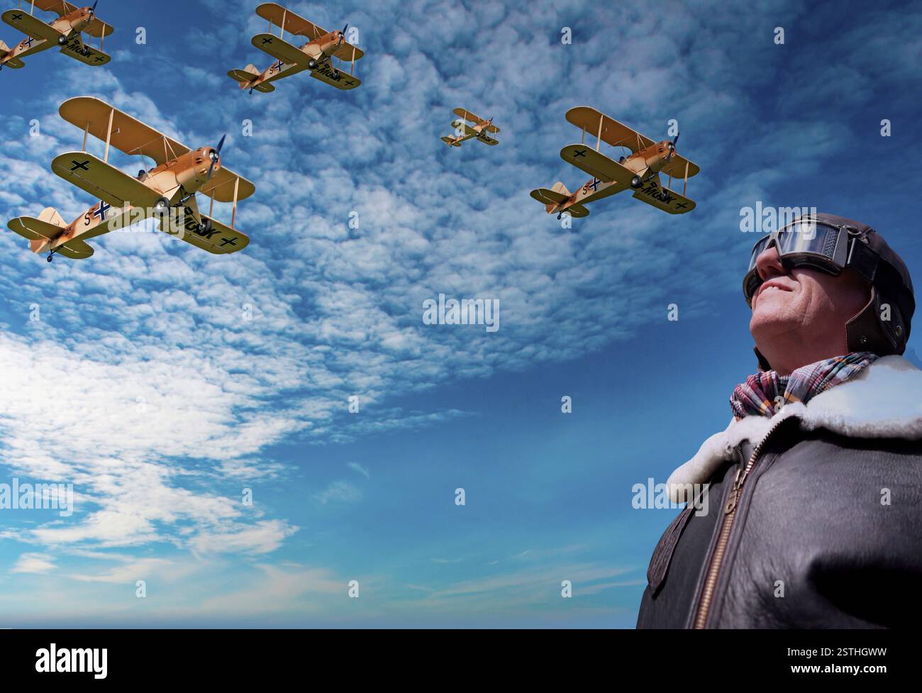 Pilot looks up at a squadron of biplanes Stock Photo - Alamy