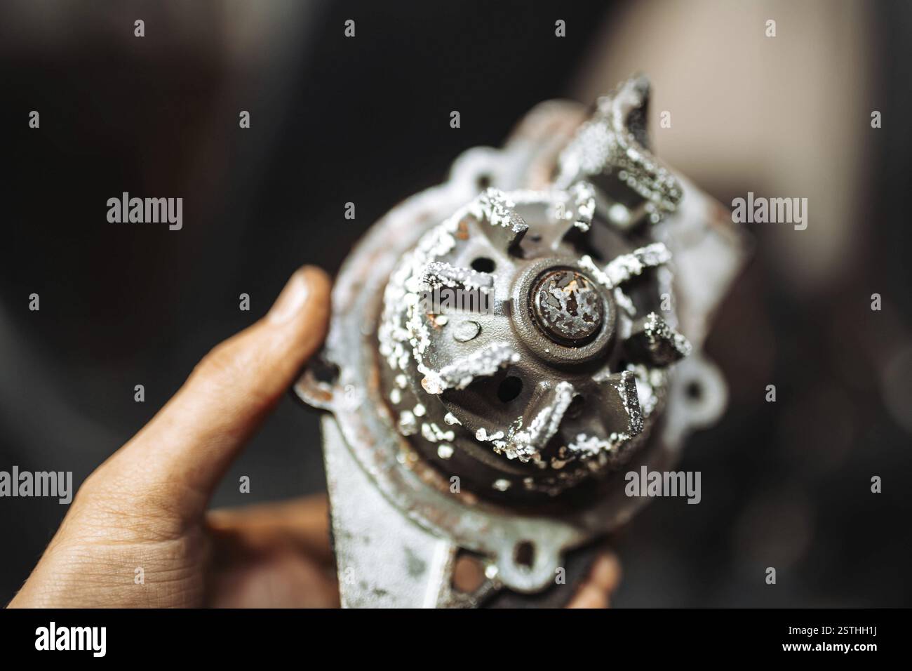 Worn, corroded car part held by a hand in a close-up view Stock Photo ...