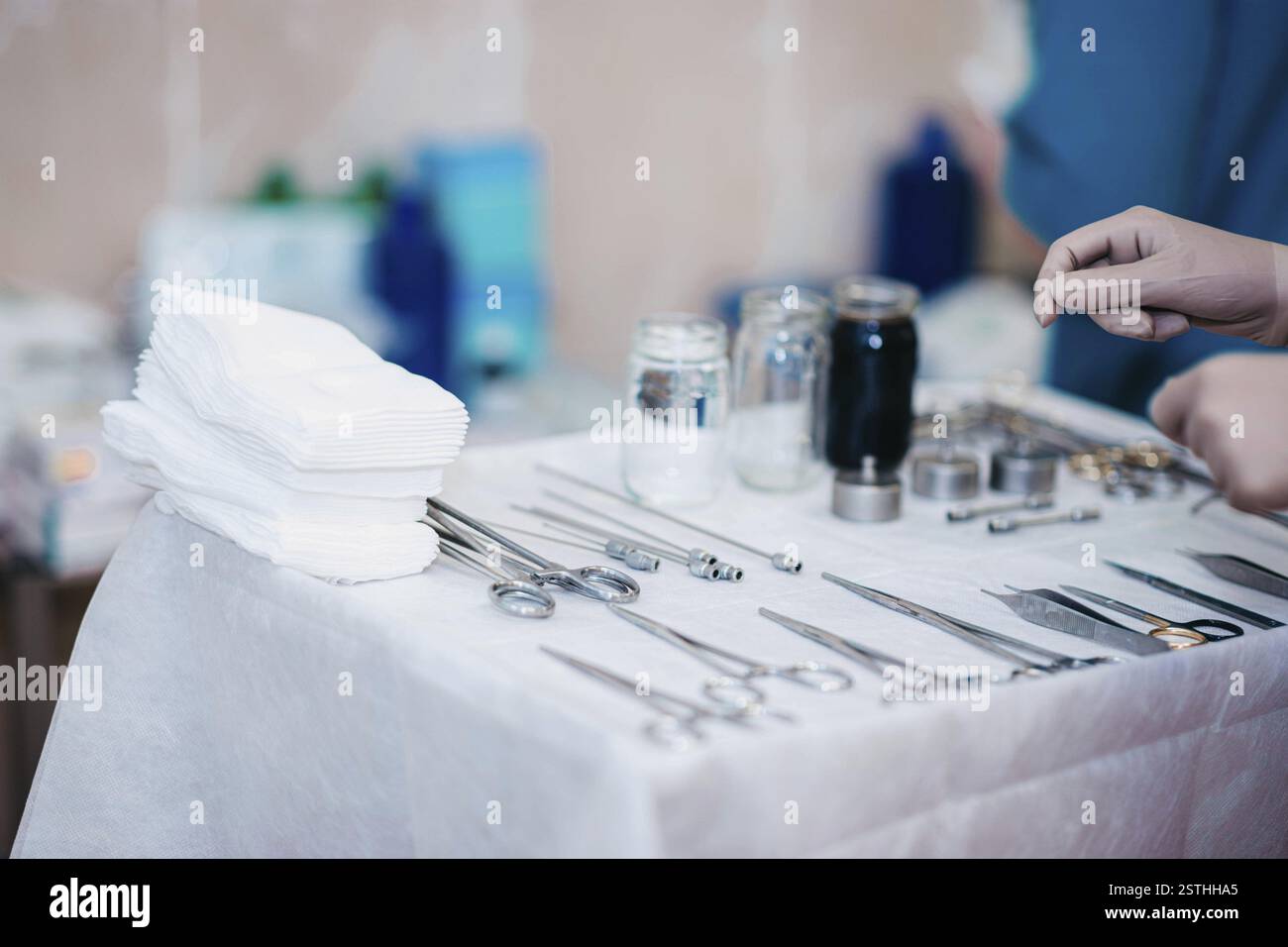 A collection of surgical tools neatly arranged on a table in a medical ...