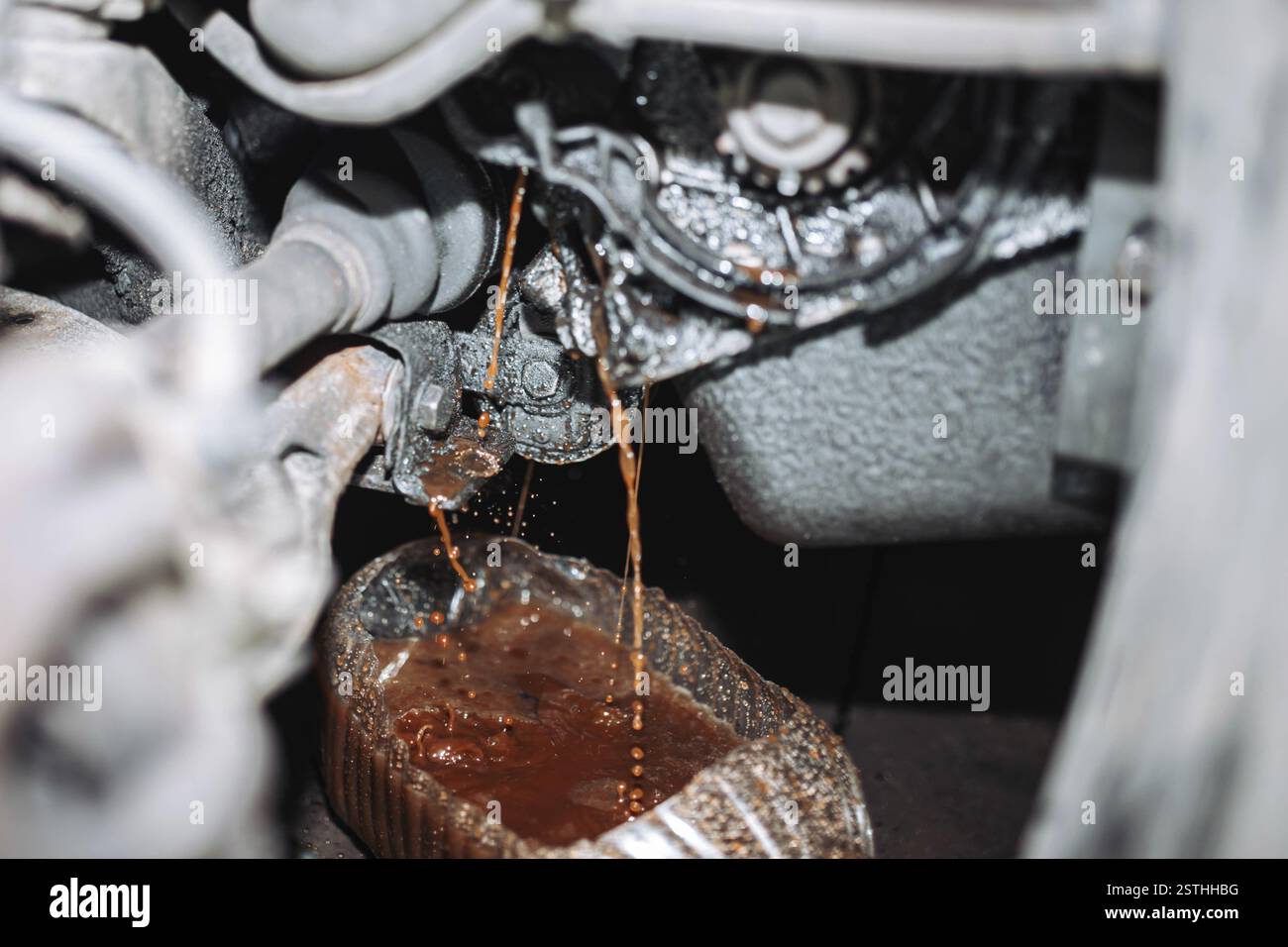 Oil leaking from automotive engine into a container in a workshop Stock ...