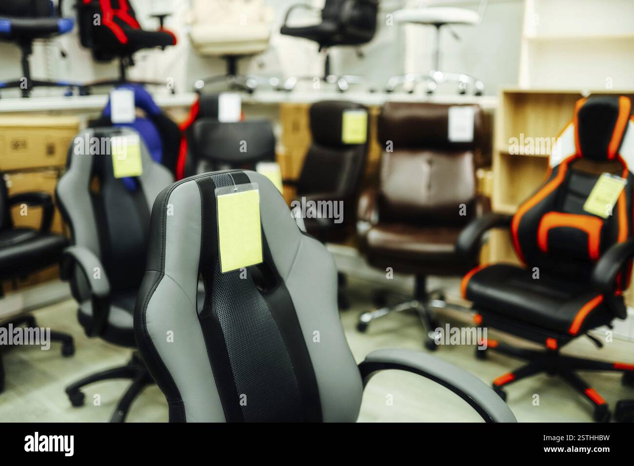 A selection of modern office chairs displayed inside a furniture store ...