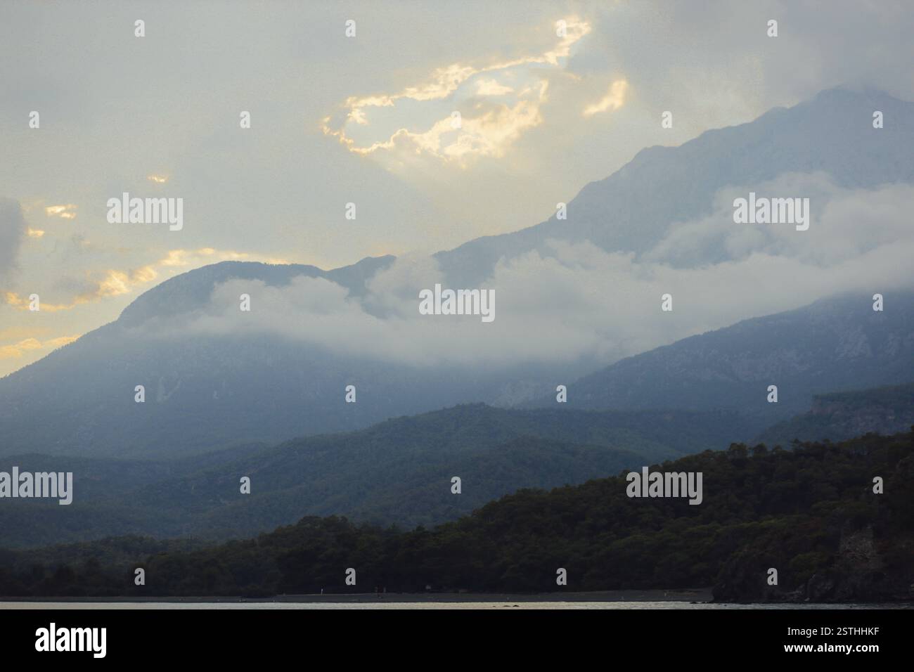 Mountains shrouded in mist and clouds during an overcast day Stock ...