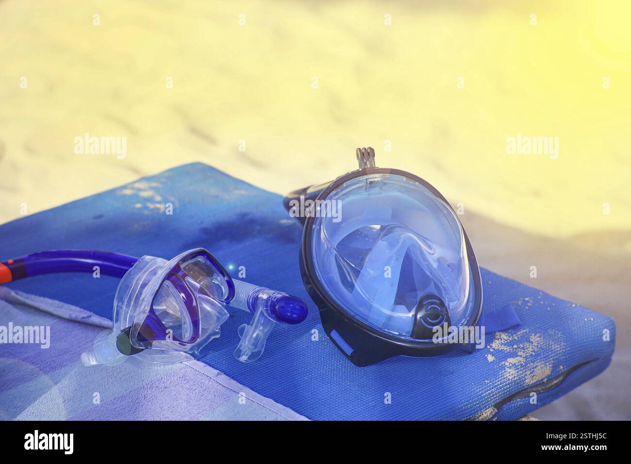 A diving mask and snorkel set on a beach towel in sunlight Stock Photo ...