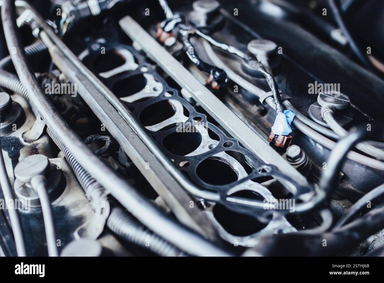Car engine with a gasket in place, showing various components and wires ...