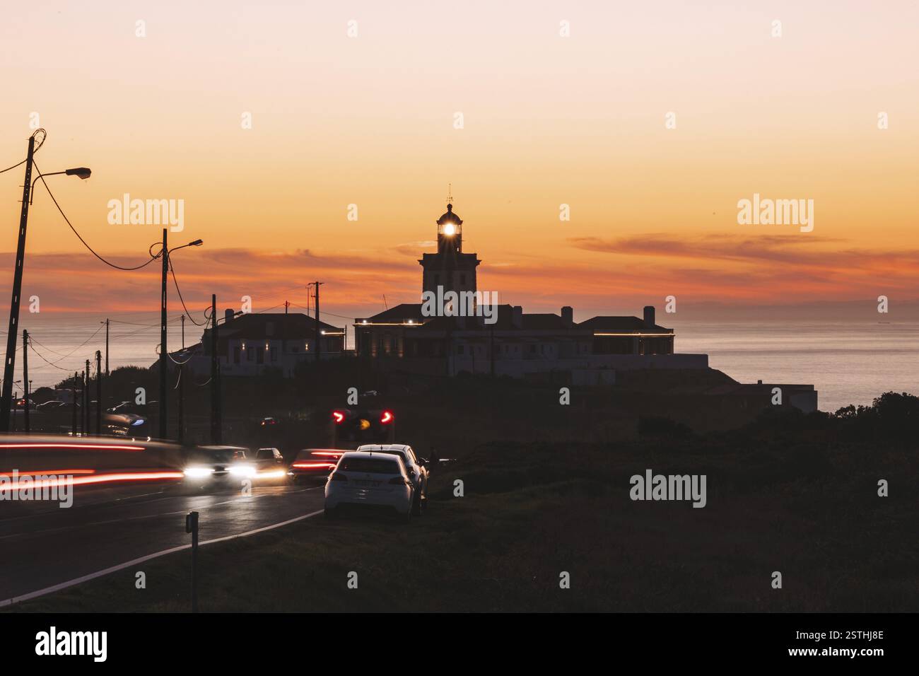 Long exposure, lighthouse, sunset, driving lights of cars Stock Photo ...