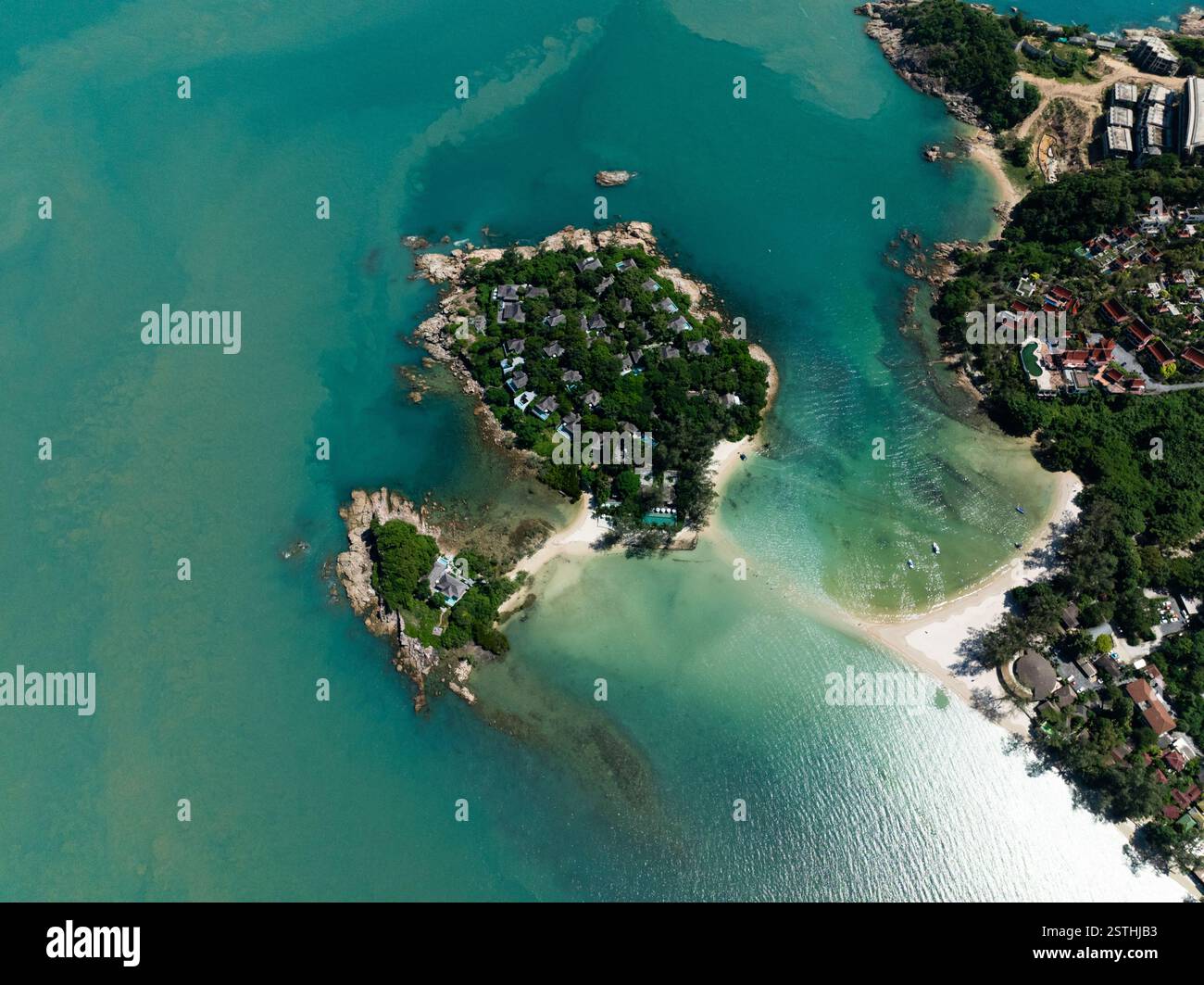 Tropical island with sandy beaches and resort villas surrounded ...