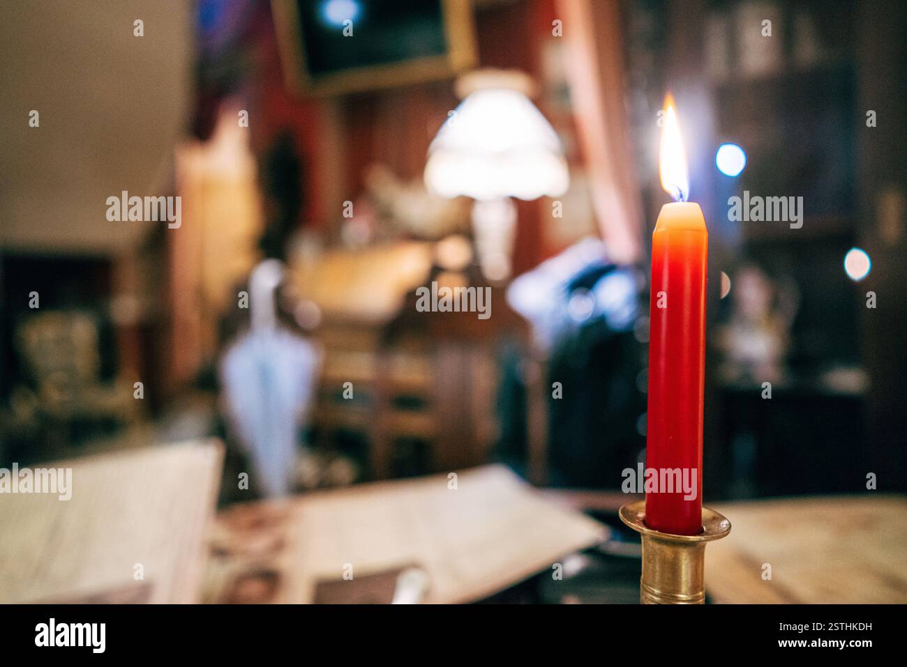 Candlesticks with red candle on the table Stock Photo - Alamy
