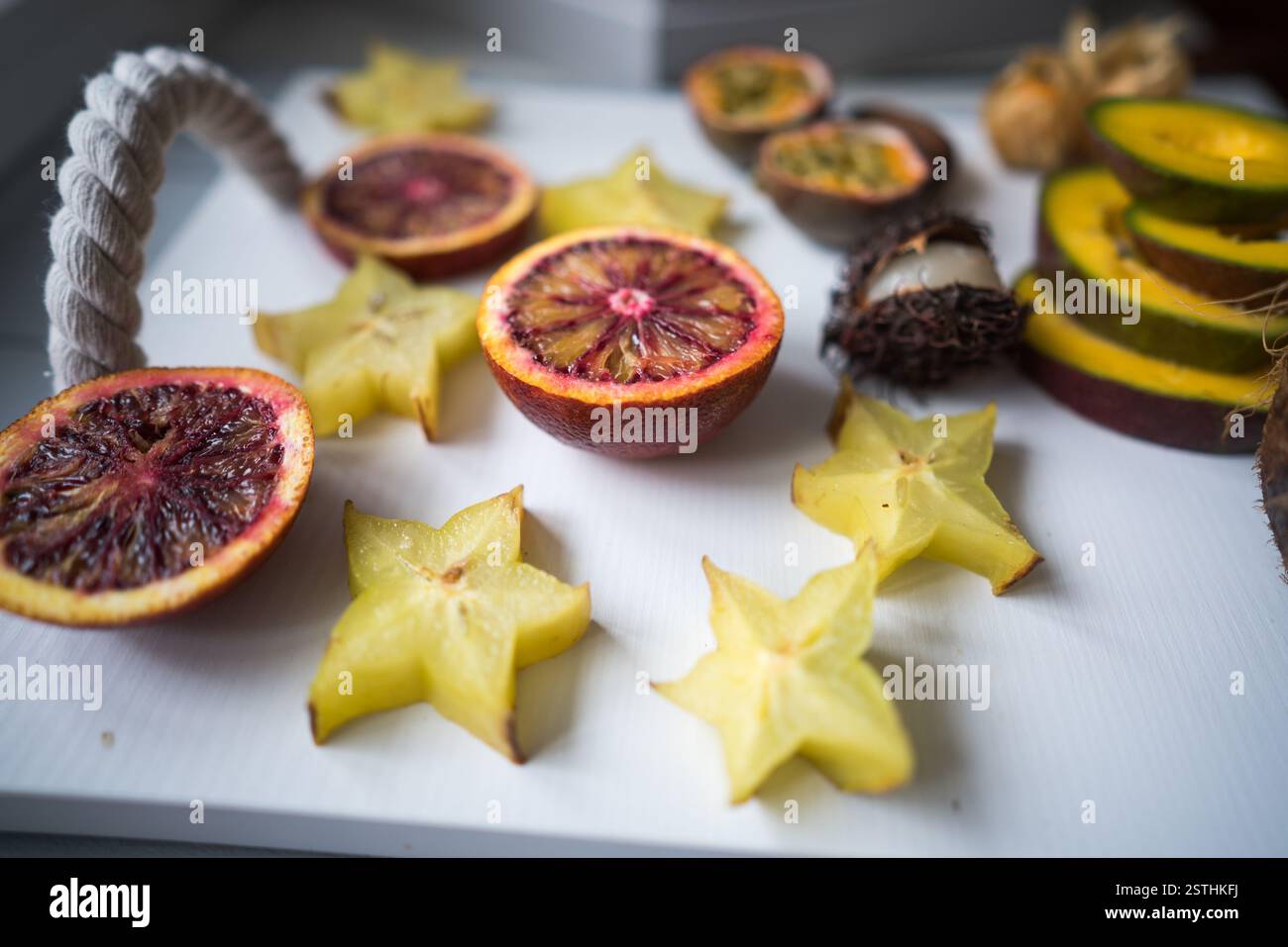 Exotic fruits on a tray on a light background Stock Photo - Alamy