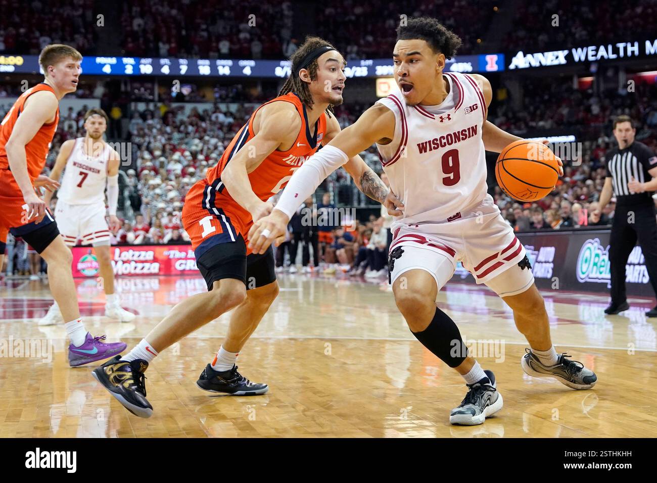 Wisconsin guard John Tonje (9) handles the ball against Illinois guard ...