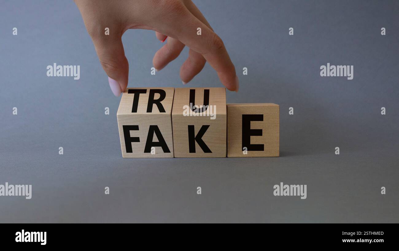 True vs Fake symbol. Businessman Hand turns cubes and changes word Fake ...