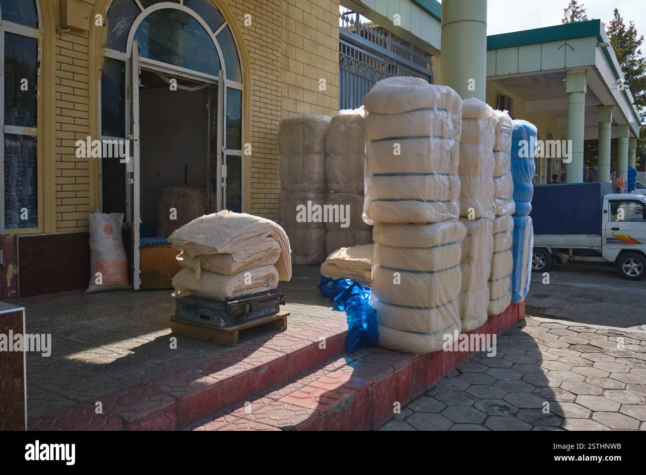 A business selling fresh bales of white, raw, processed cotton. In ...