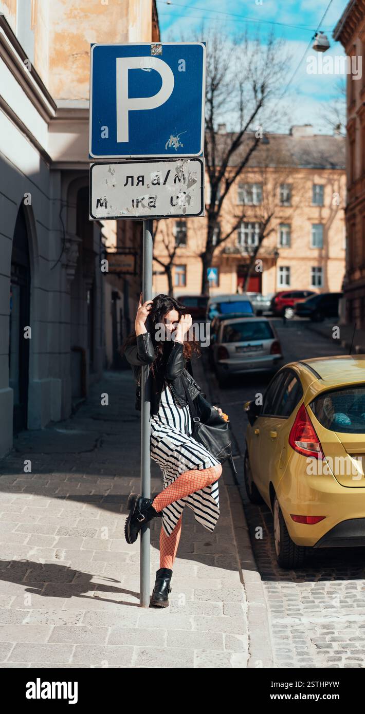 Beautiful fashionable lady posing on old street Stock Photo - Alamy