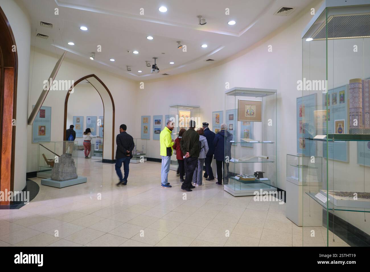 Visitors looking at measuring tools, artifacts inside the museum. At ...