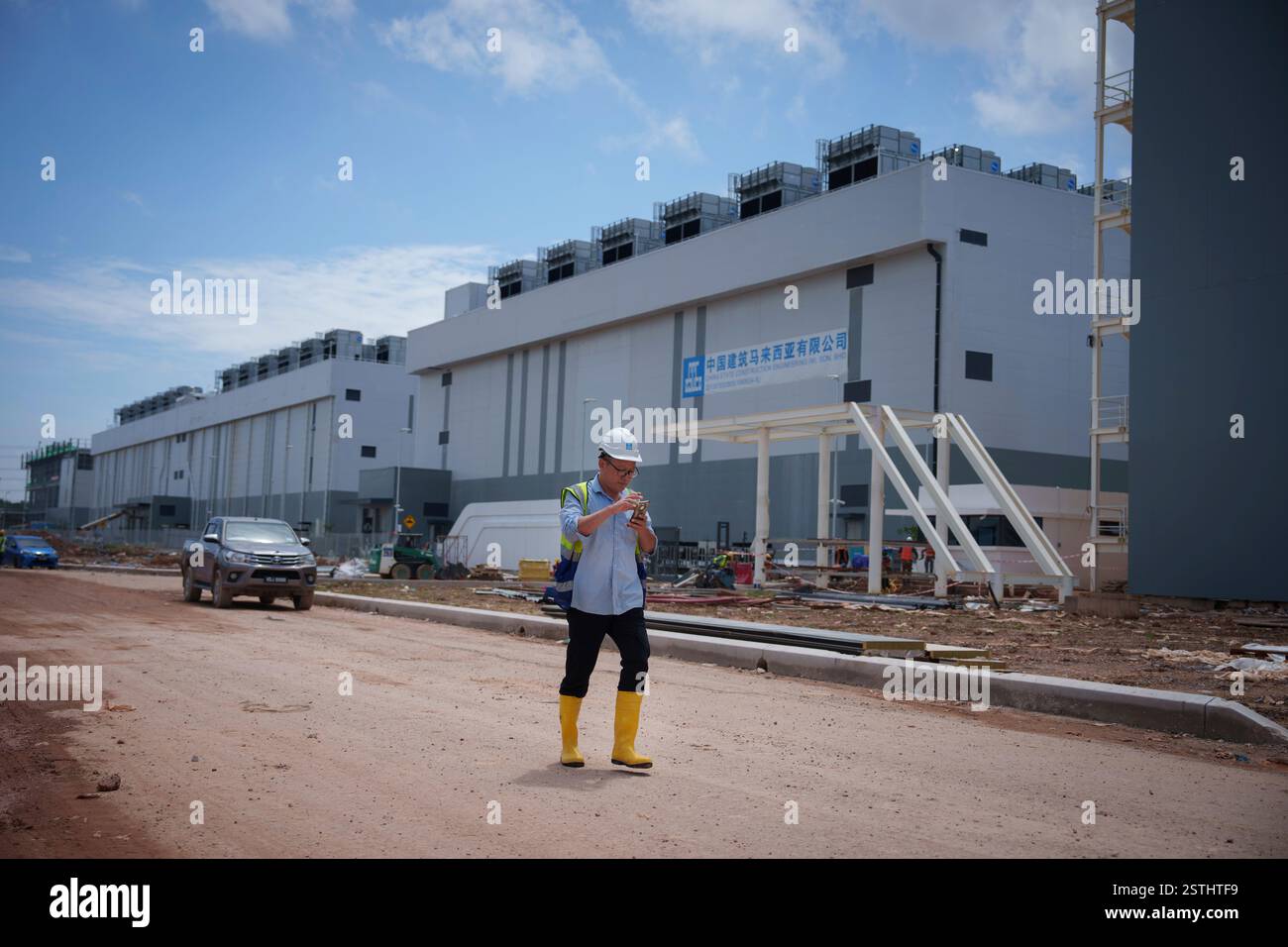 Construction workers walk outside a Data center building in ...