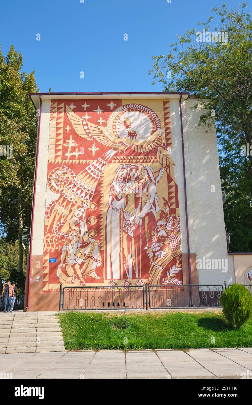 A recent, current giant wall mural on a building. An Uzbek theme of ...