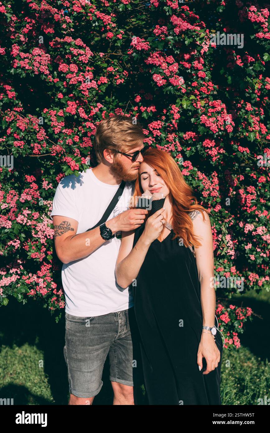Couple in park eating ice cream cones Stock Photo - Alamy