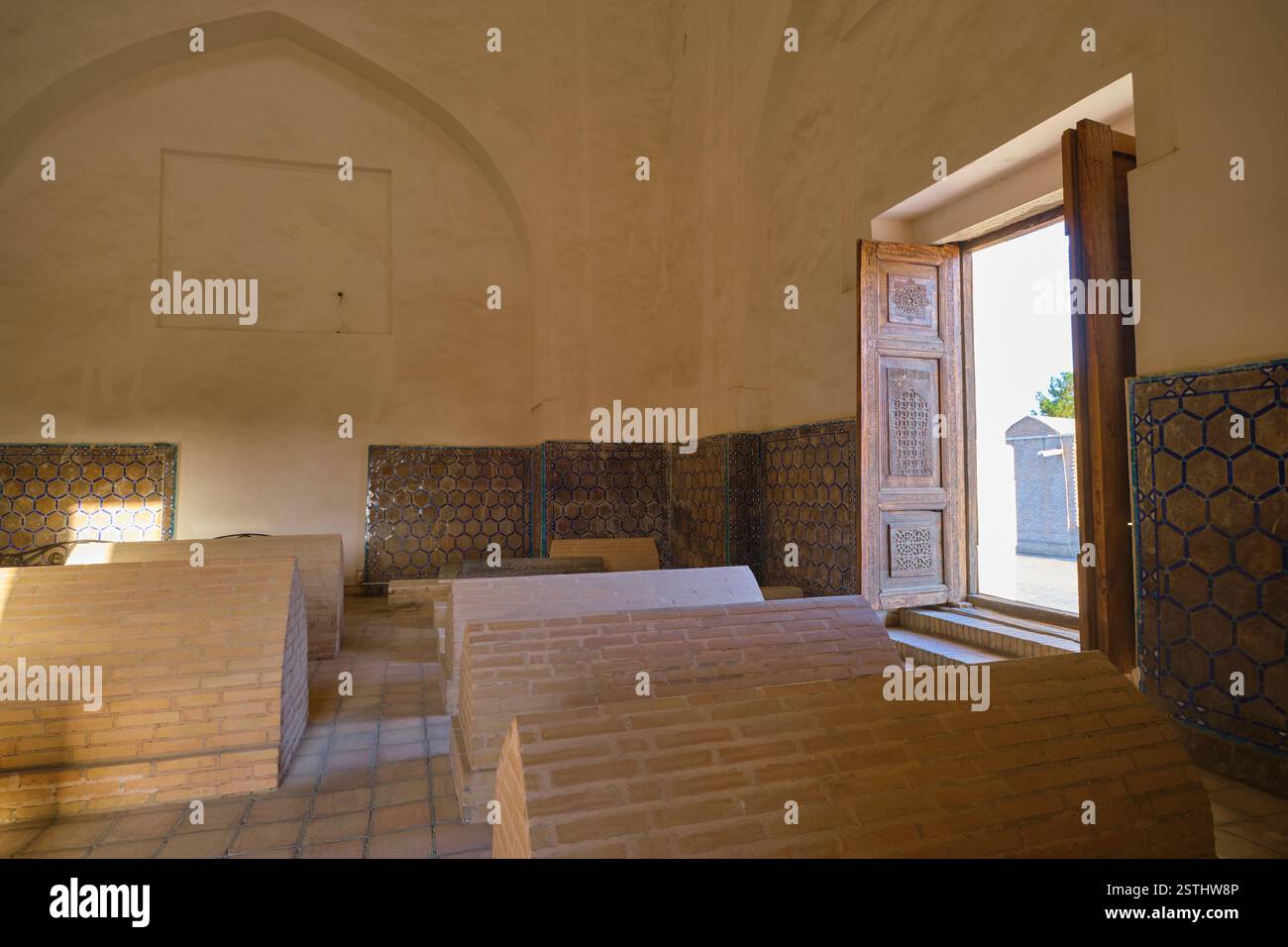 Interior view with simple, brick graves. At Ruhabad, Rukhobod Mausoleum ...