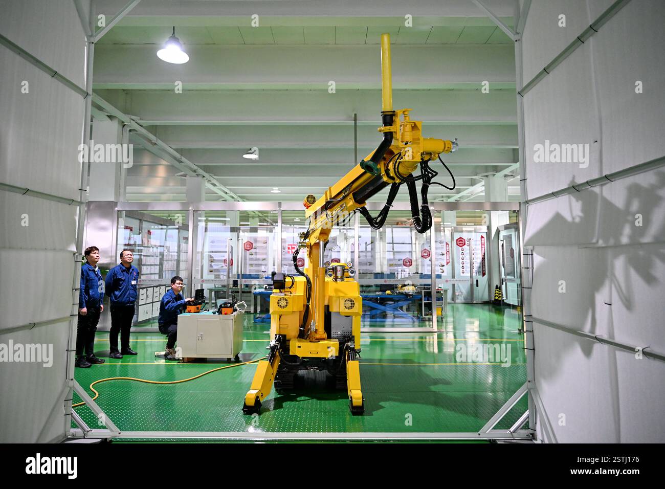 (250219) -- TANGSHAN, Feb. 19, 2025 (Xinhua) -- Workers test a robot ...
