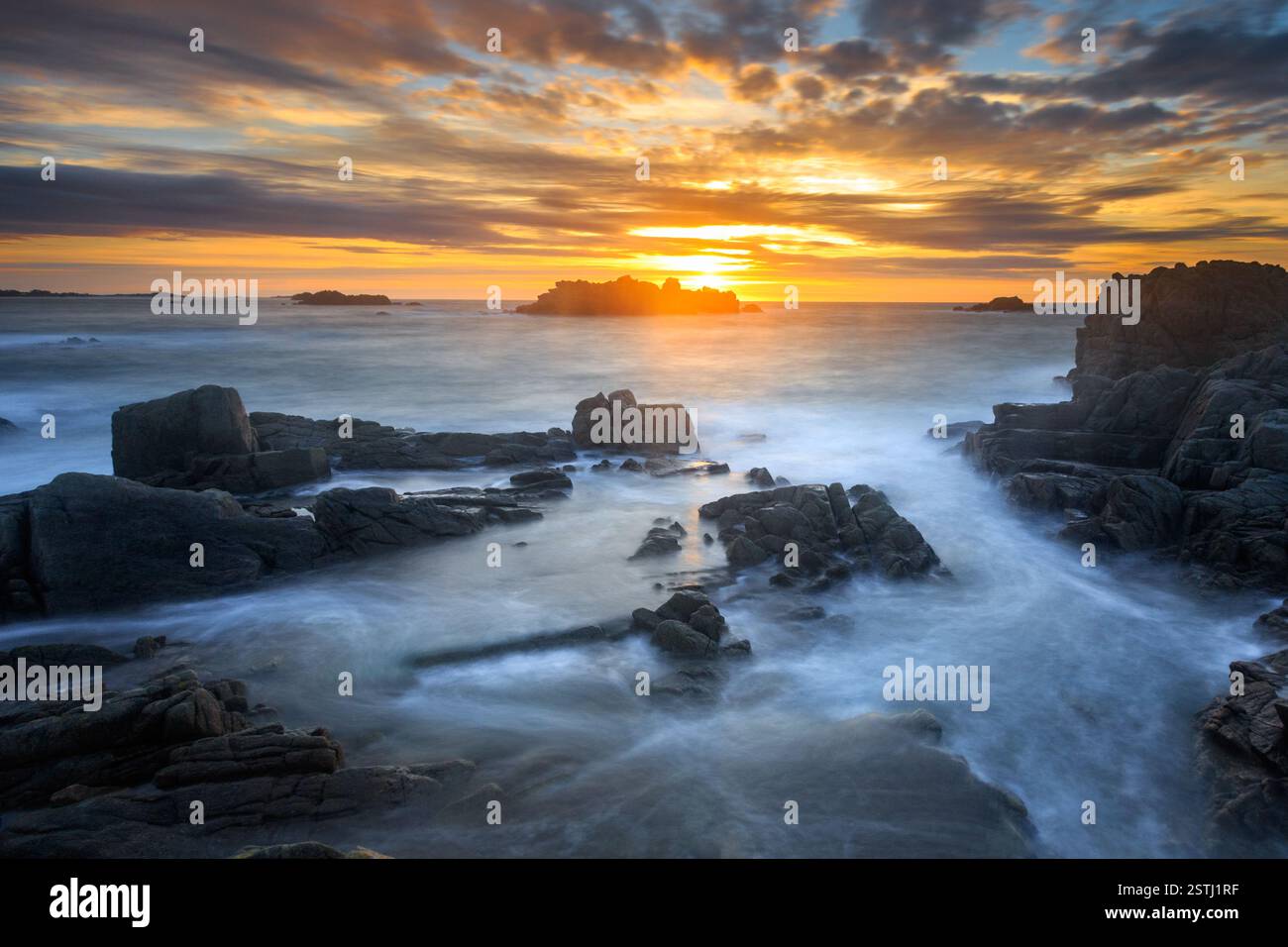 Sunset at Cobo Stock Photo - Alamy