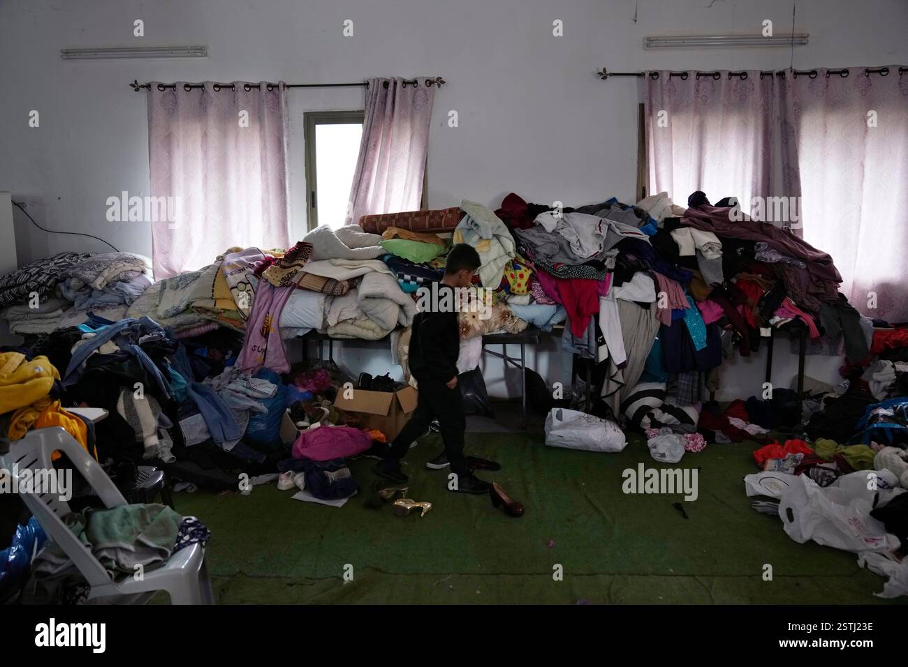 A Palestinian boy who fled the Israeli army operation in the Nur Shams ...