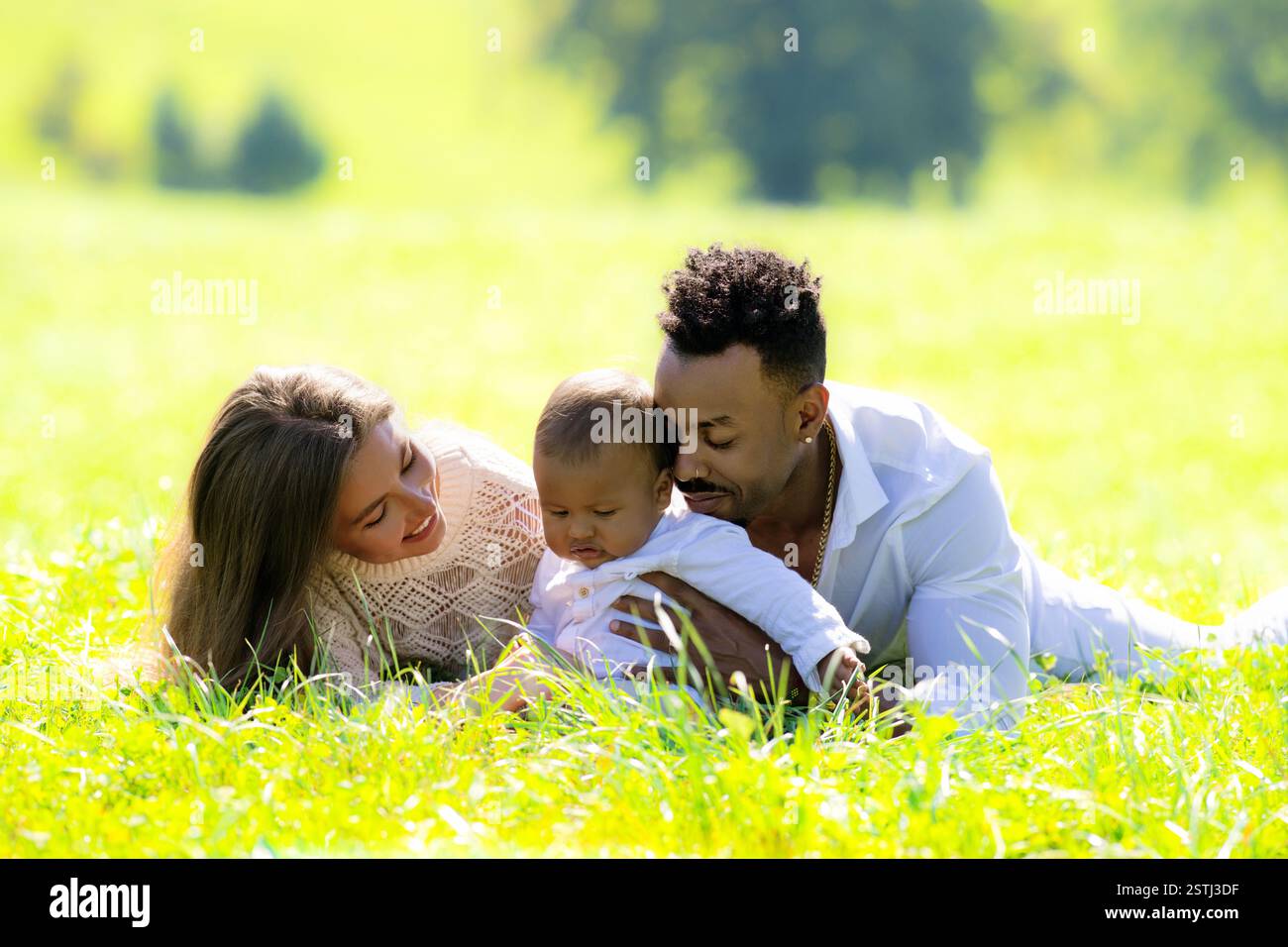 Multiethnic parents and mixed race baby in park. Multiethnic family ...