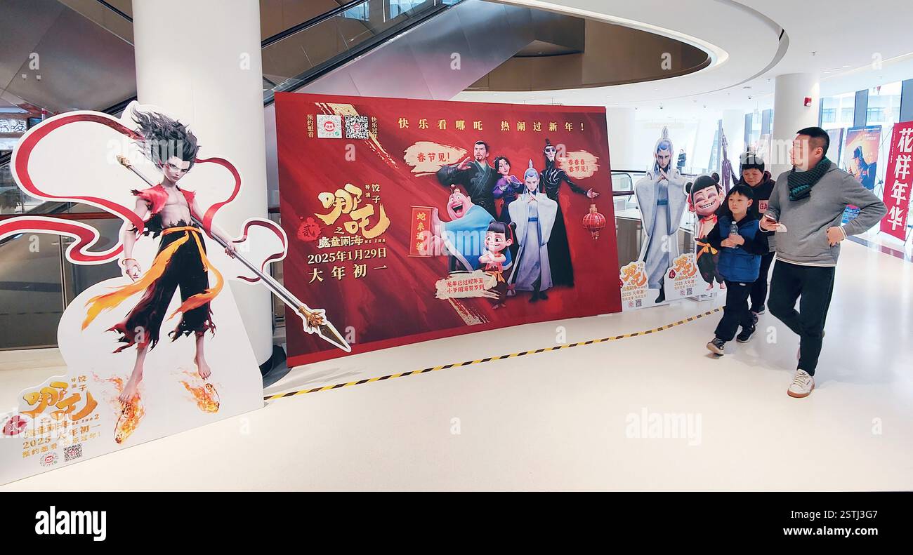 People walk past the promotion for the Chinese animated film Ne Zha 2 ...