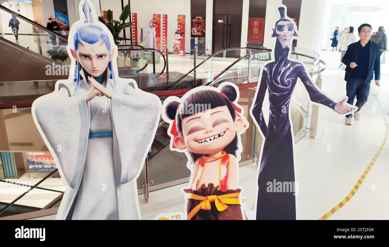 People walk past the promotion for the Chinese animated film Ne Zha 2 ...