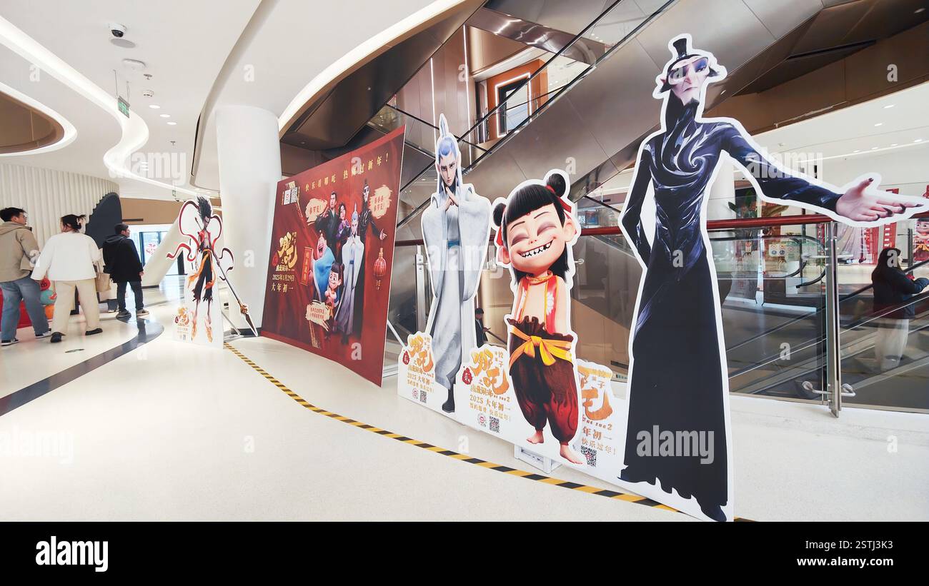 People walk past the promotion for the Chinese animated film Ne Zha 2 ...