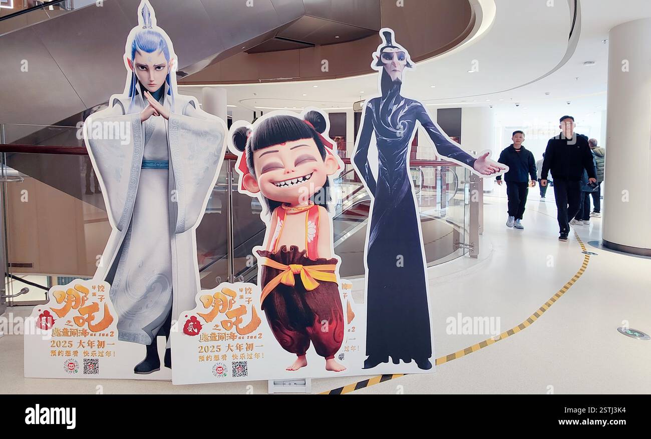 People walk past the promotion for the Chinese animated film Ne Zha 2 ...