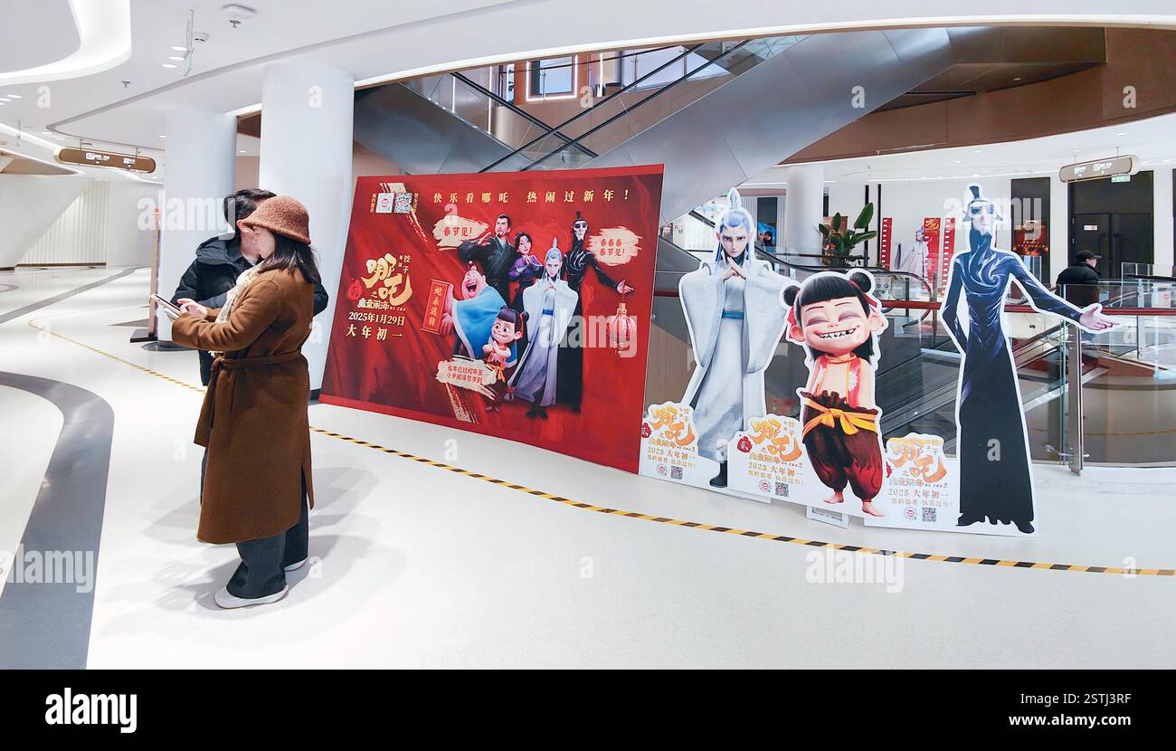 People walk past the promotion for the Chinese animated film Ne Zha 2 ...