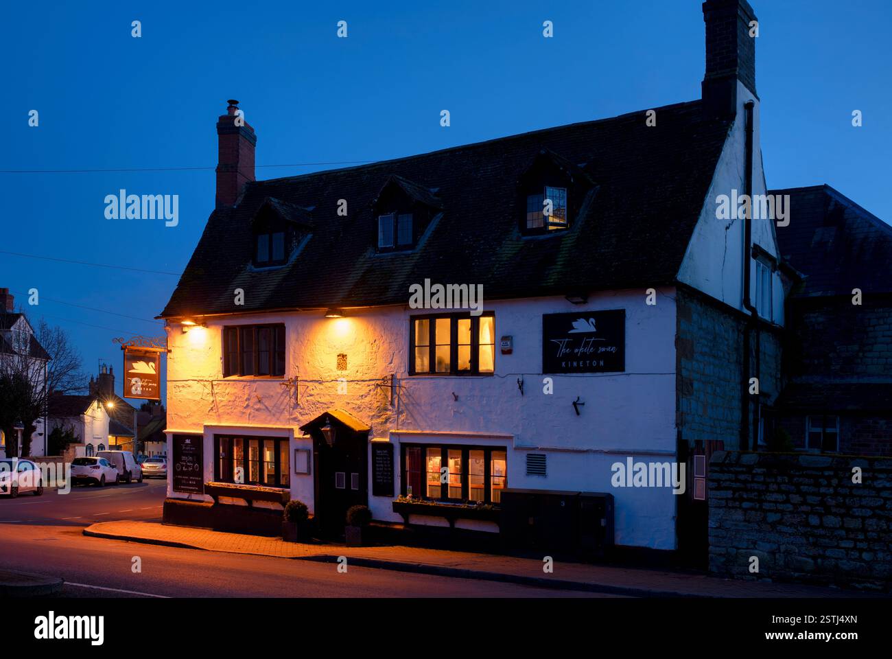 The White Swan pub at dusk. Kineton, Warwickshire, England Stock Photo ...