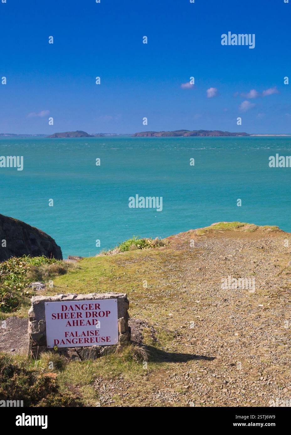 Danger Sign Sheer drop ahead on sark Stock Photo - Alamy