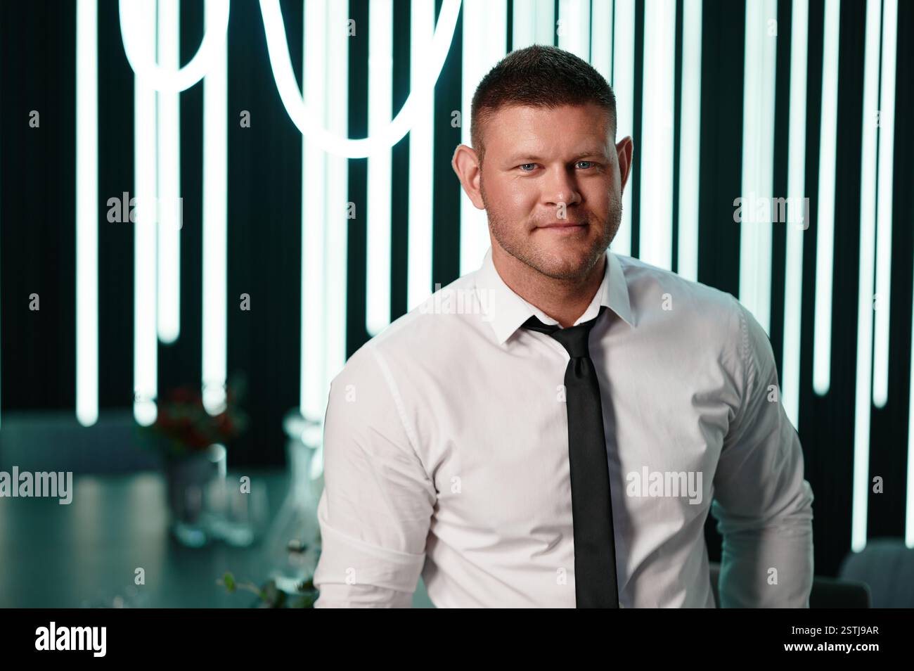 Close-up portrait of a young ambitious man in white shirt and tie ...