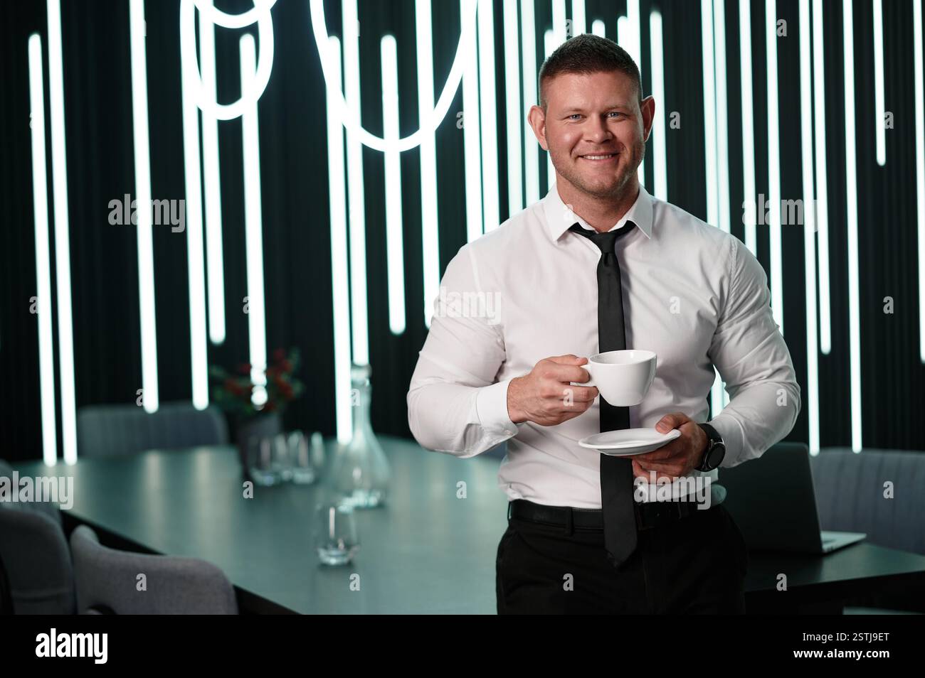 Handsome caucasian businessman in formal wear, holding a cup of coffee ...