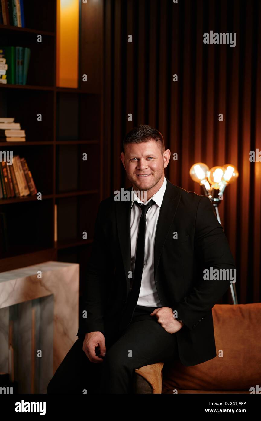 Portrait of a young lawyer with a smile on his face wearing a suit and ...