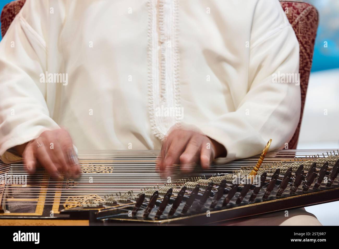 Traditional moroccan musician with wooden string instrument. Qanun ...
