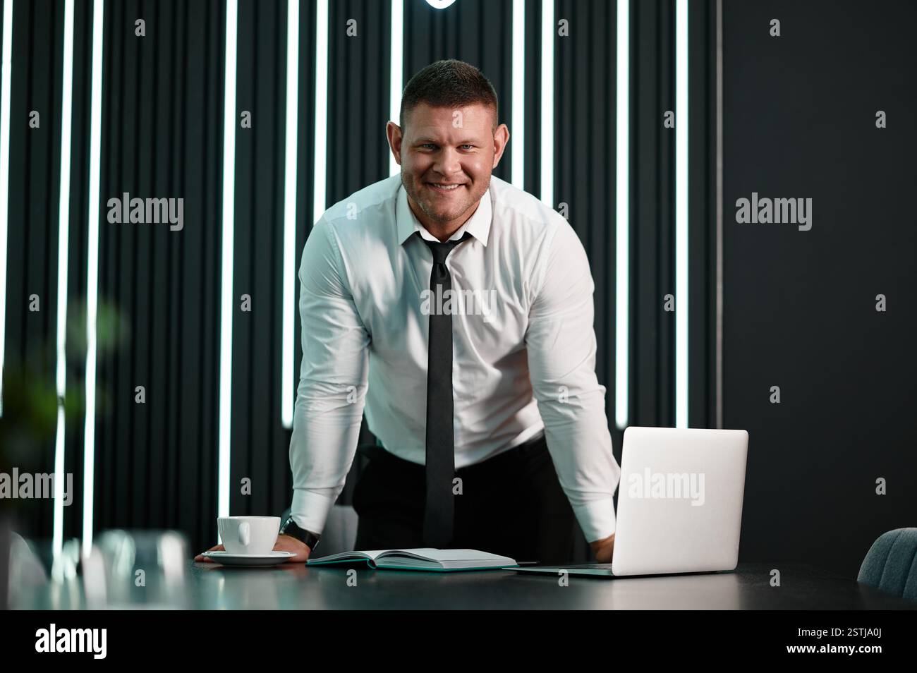 Portrait of businessman in high tech start up office. Young manager in ...