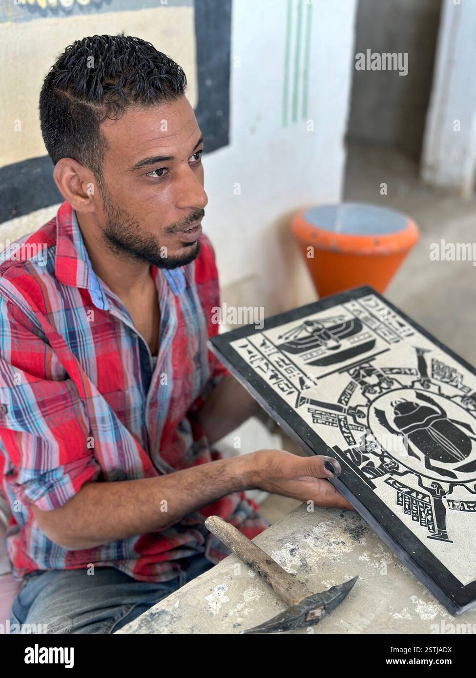 Luxor, Egypt - October 23, 2023: A sculptor works in an alabaster ...