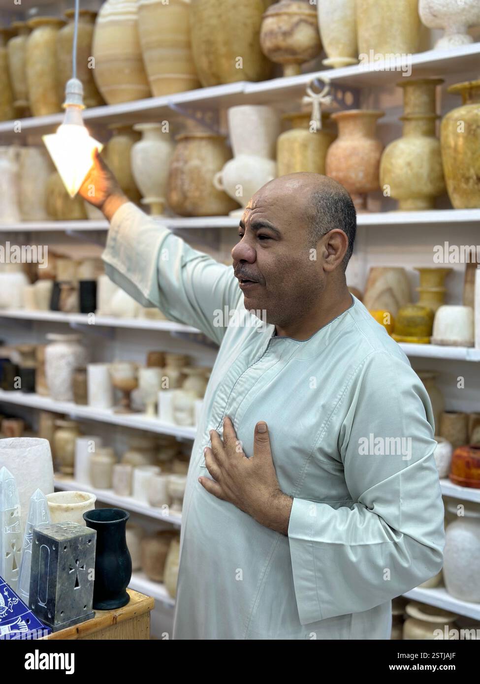 Luxor, Egypt - October 23, 2023: An Egyptian explaining the alabaster ...