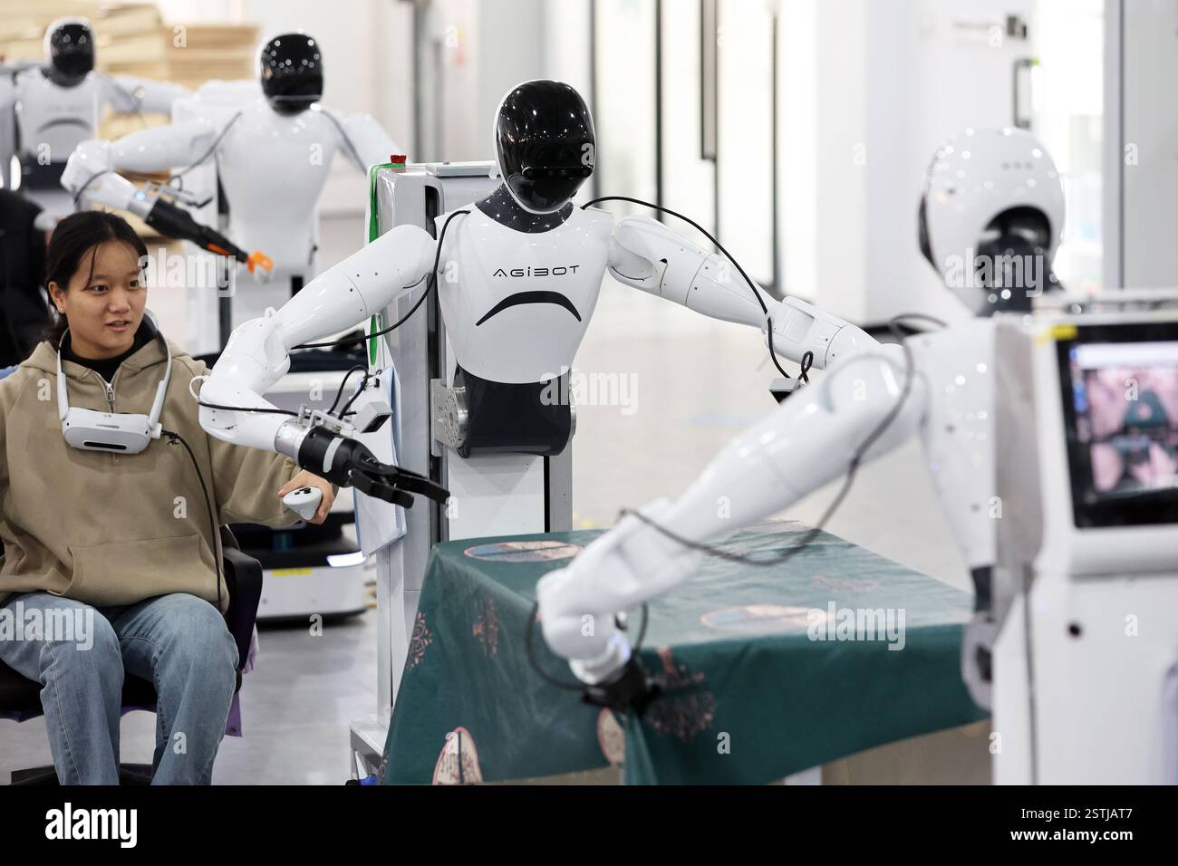 Shanghai,China.18th February 2025. An engineer trains humanoid robots ...