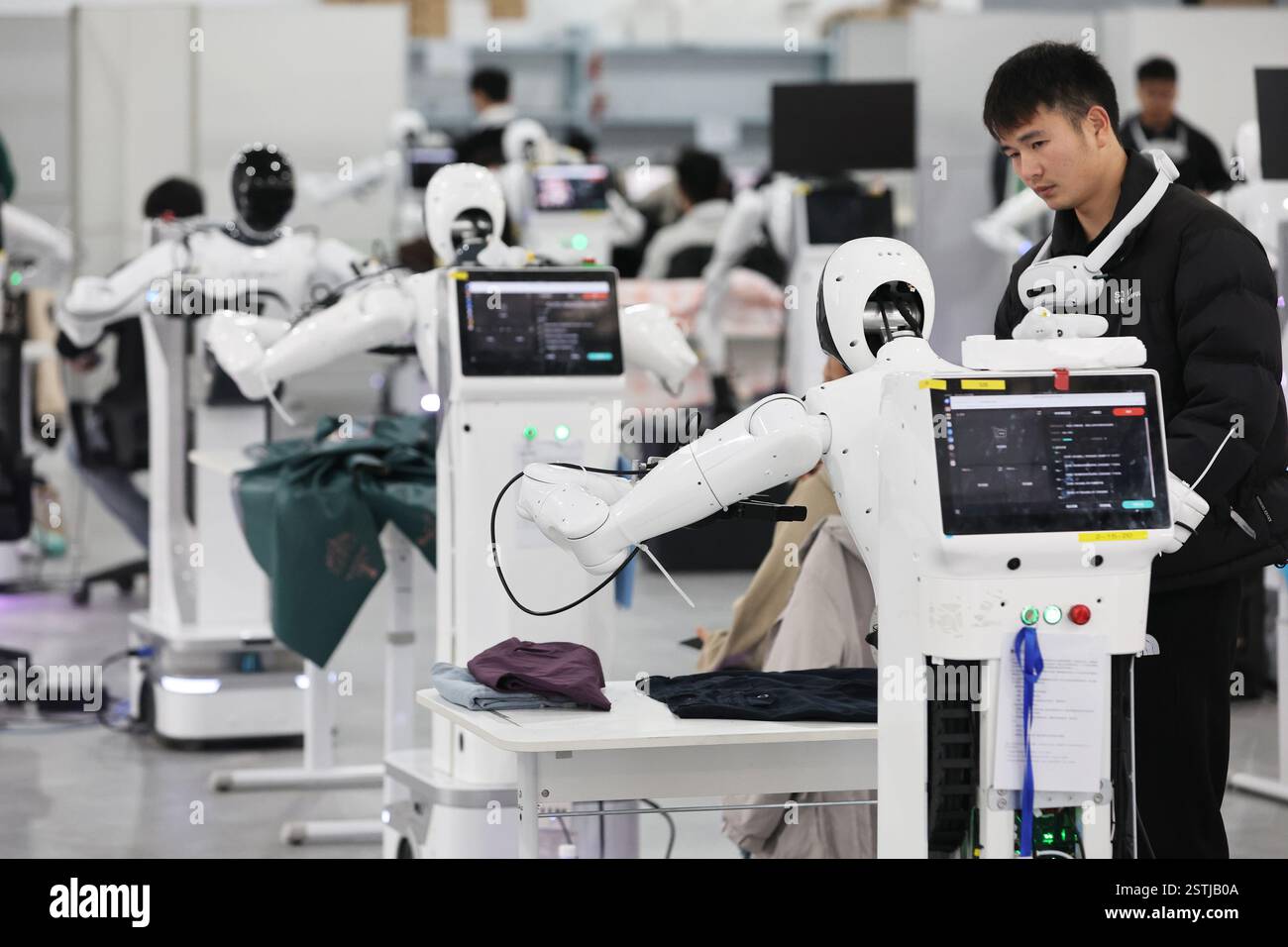Shanghai,China.18th February 2025. Engineers train humanoid robots at ...
