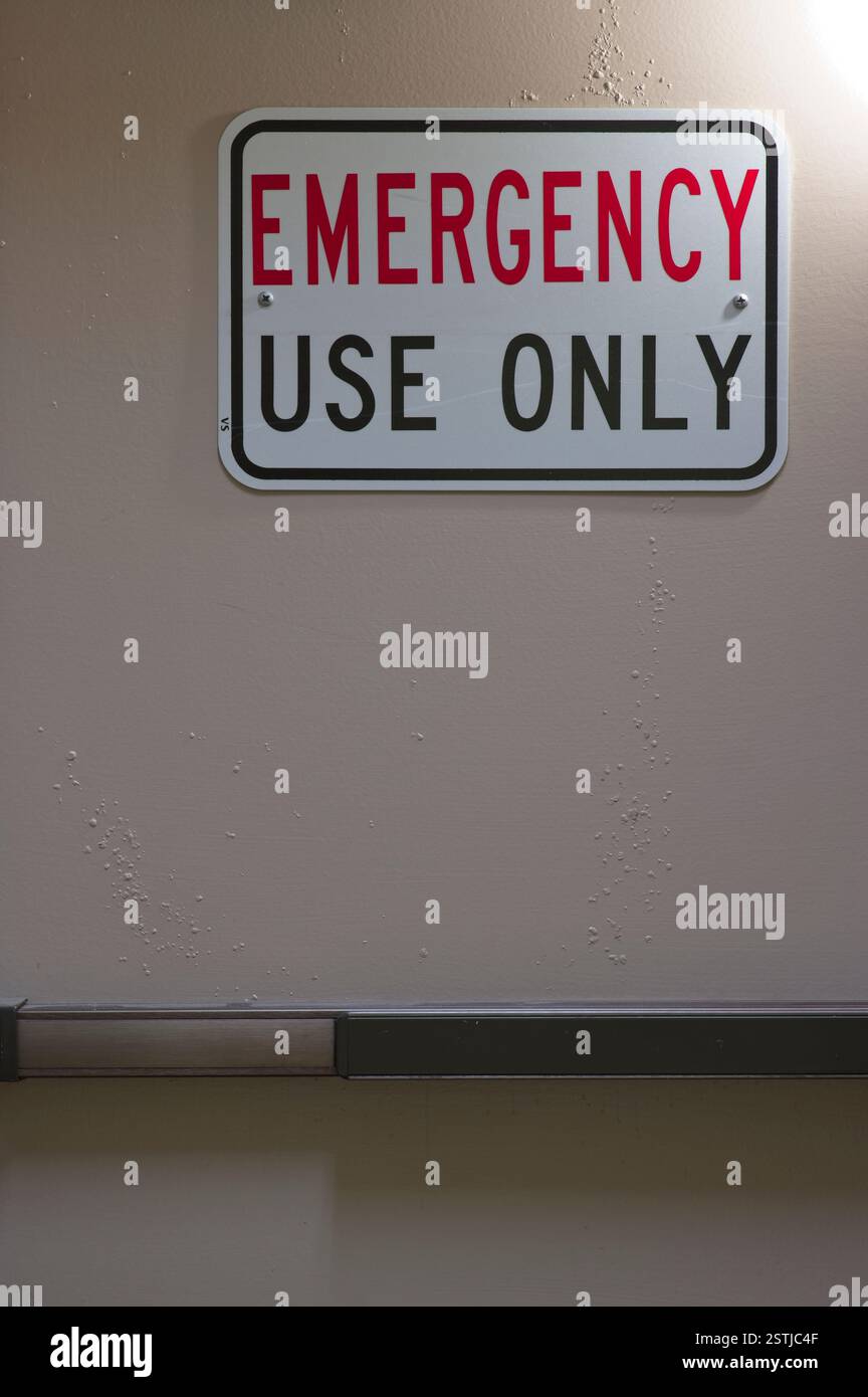 Emergency exit door with sign that reads, ""Emergency Use Only Stock ...