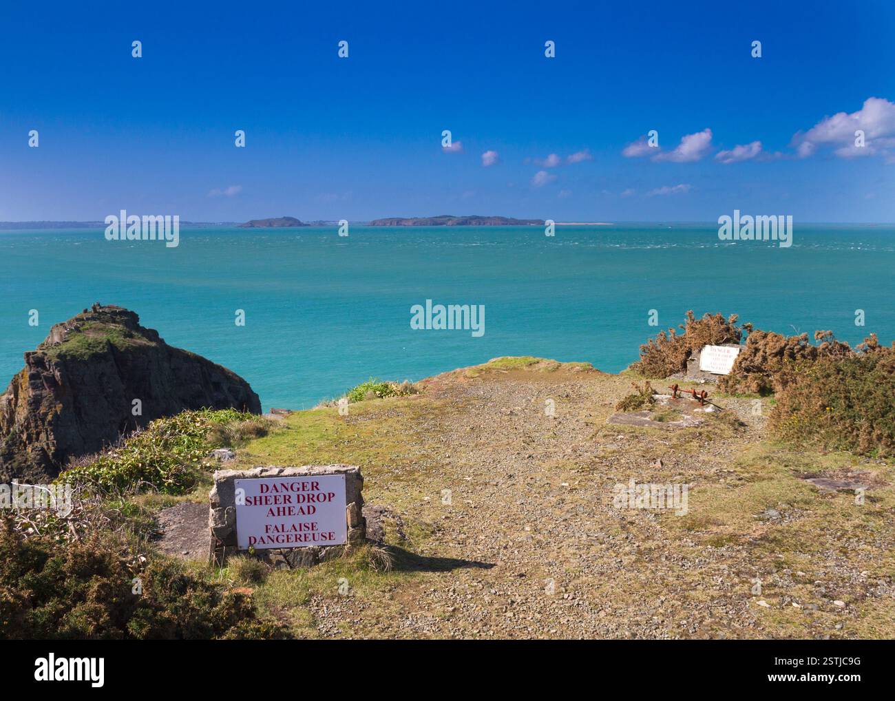 Danger Sign Sheer drop ahead on sark Stock Photo - Alamy